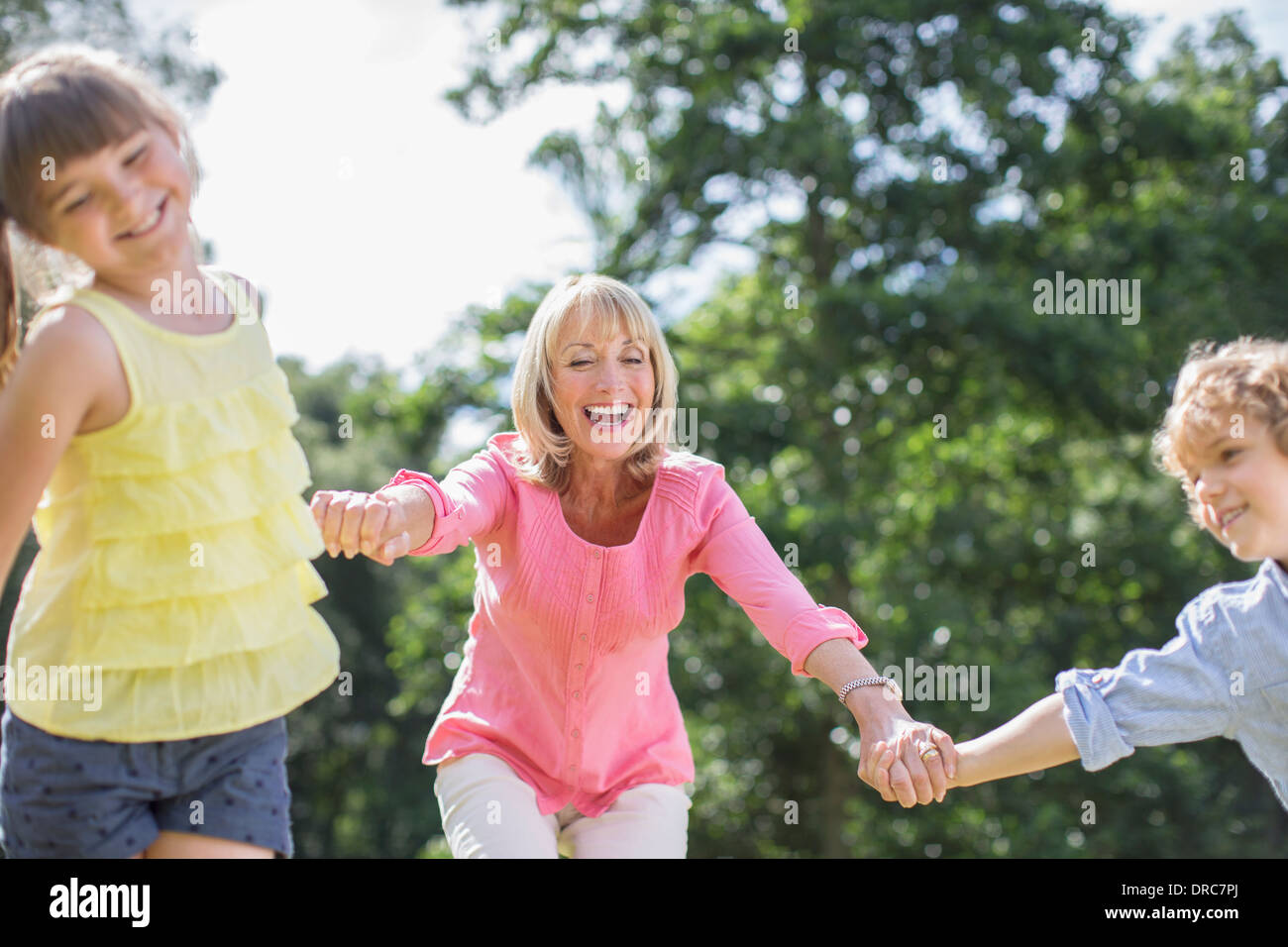 Grandmother and grandchildren playing outdoors Stock Photo - Alamy
