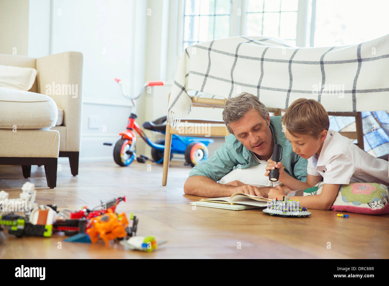 Father and son reading together Stock Photo - Alamy