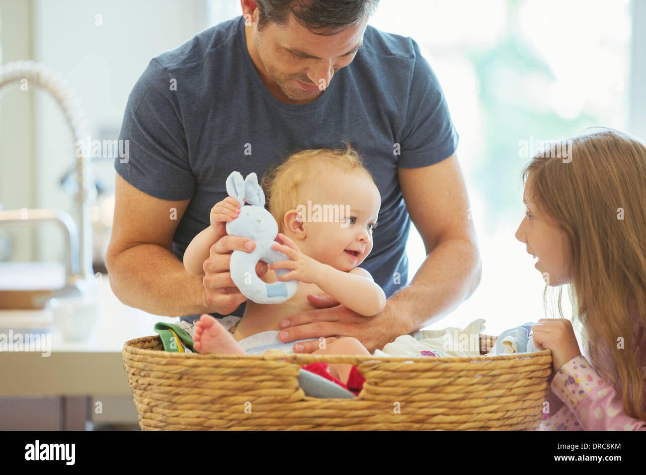 Father and children sorting laundry Stock Photo - Alamy