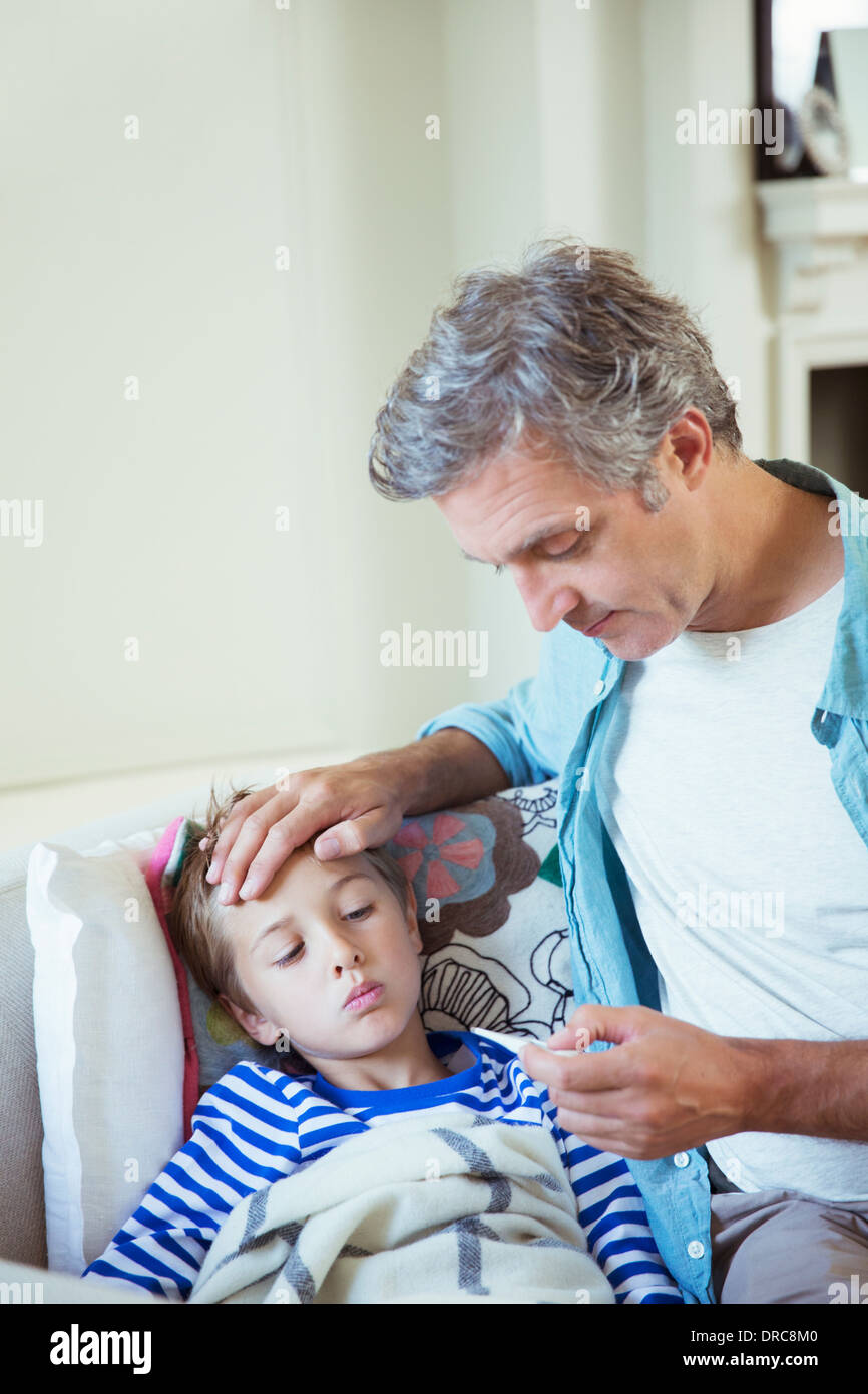 Father checking son's temperature Stock Photo - Alamy