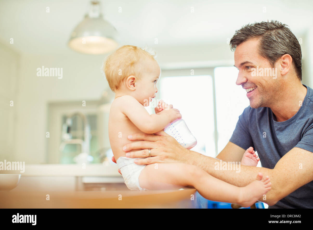 Father feeding baby in kitchen Stock Photo - Alamy