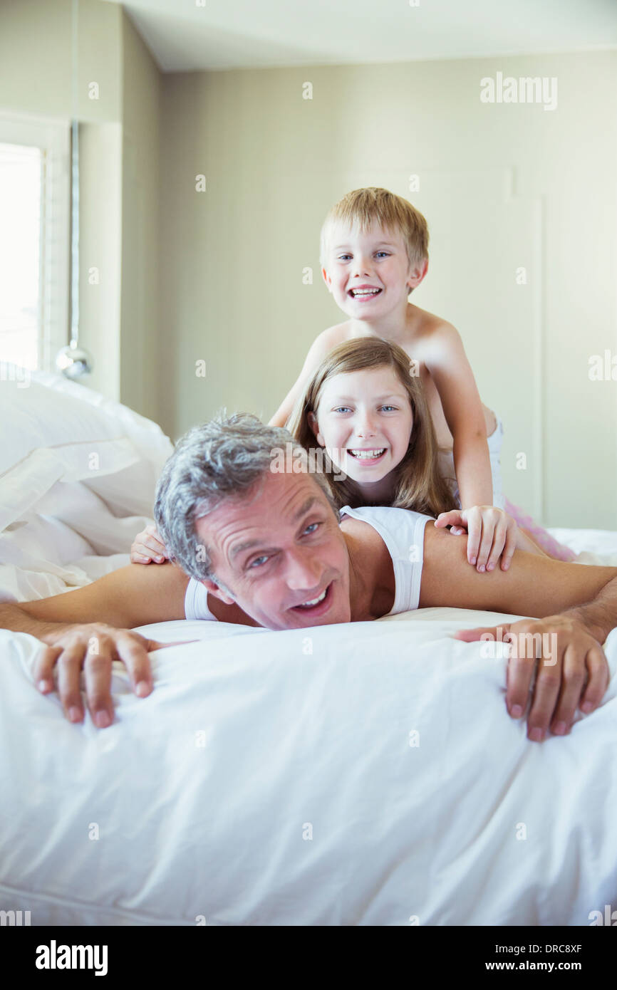 Father playing with his daughter on bed hi-res stock photography and ...
