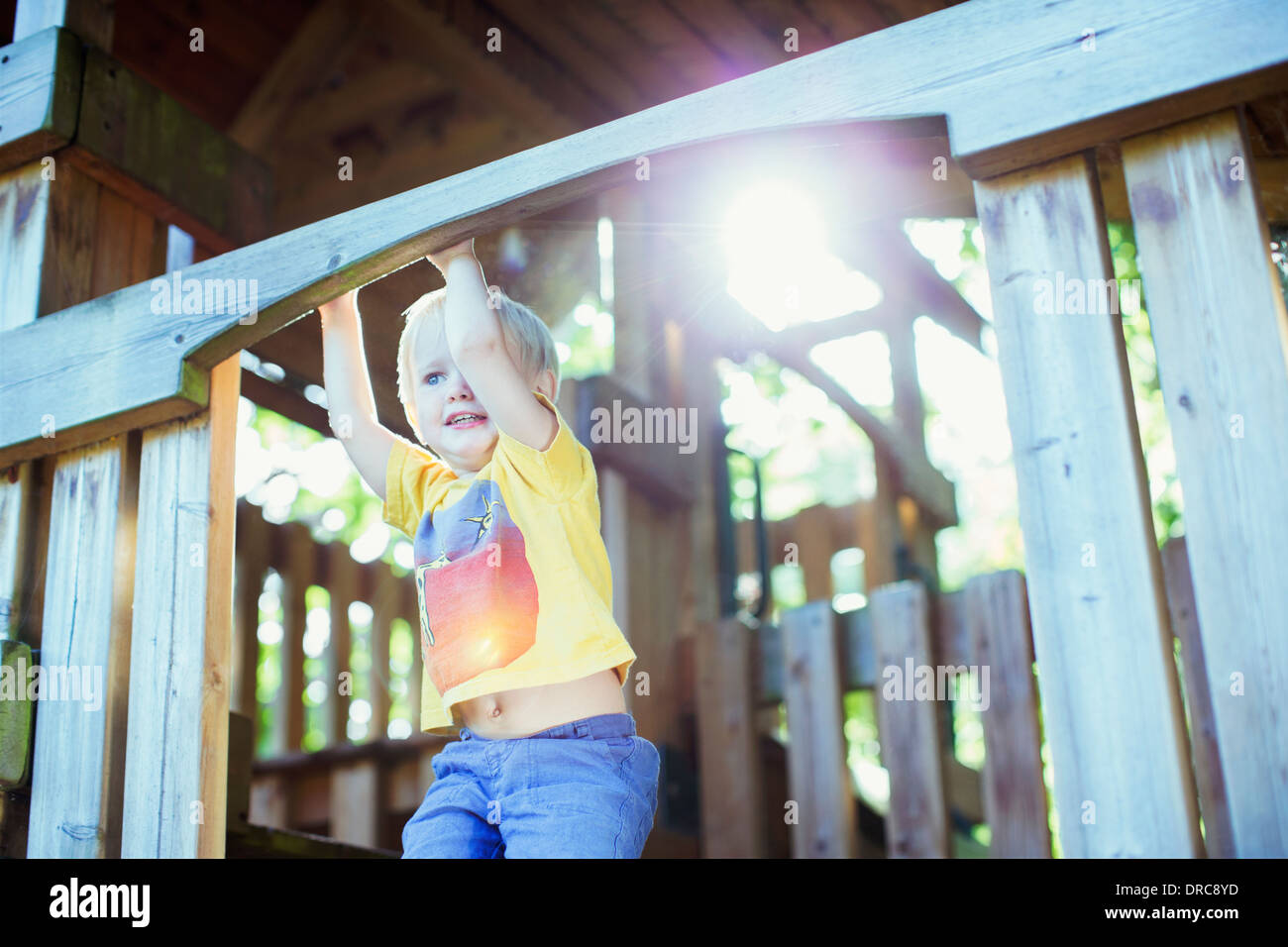 Boy playing on play structure outdoors Stock Photo - Alamy