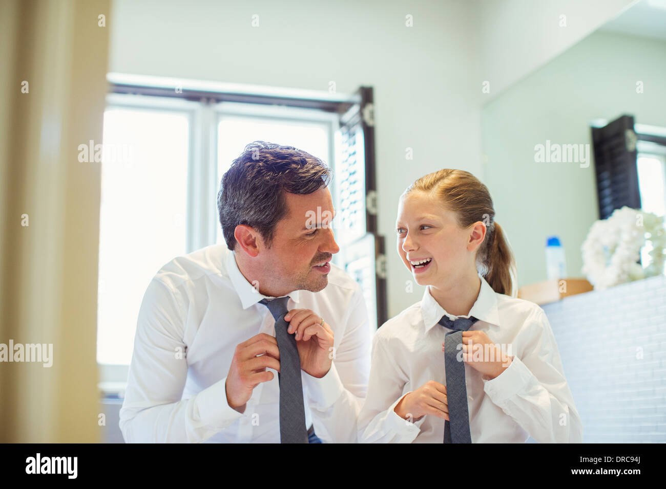 Father and daughter tying ties in bathroom Stock Photo - Alamy