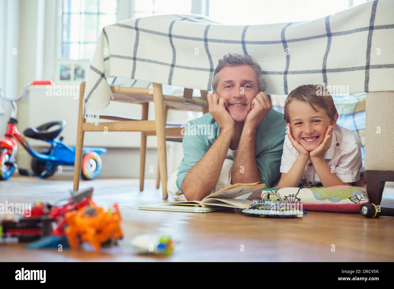 Father and son reading together Stock Photo - Alamy
