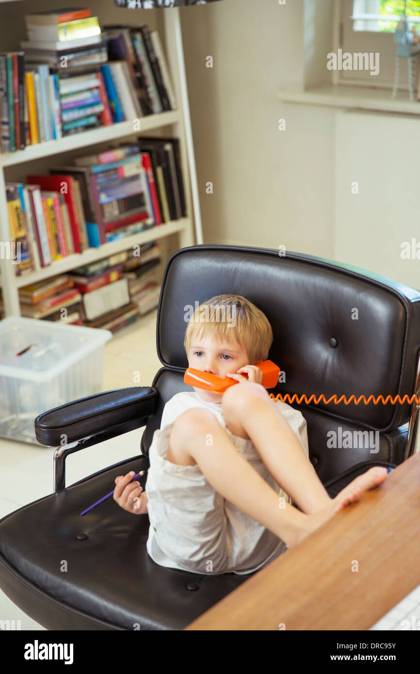 Boy talking on telephone Stock Photo - Alamy