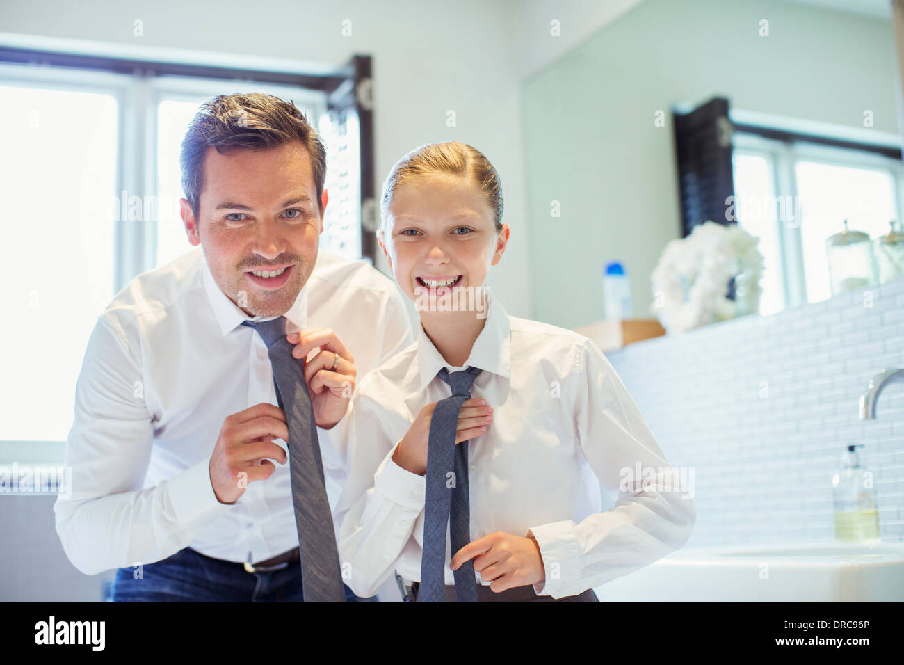Father and daughter adjusting ties in bathroom Stock Photo - Alamy