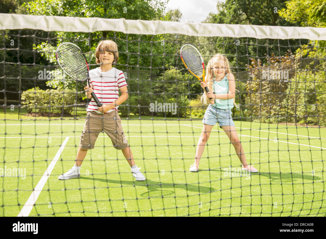 Children playing tennis on grass court Stock Photo - Alamy