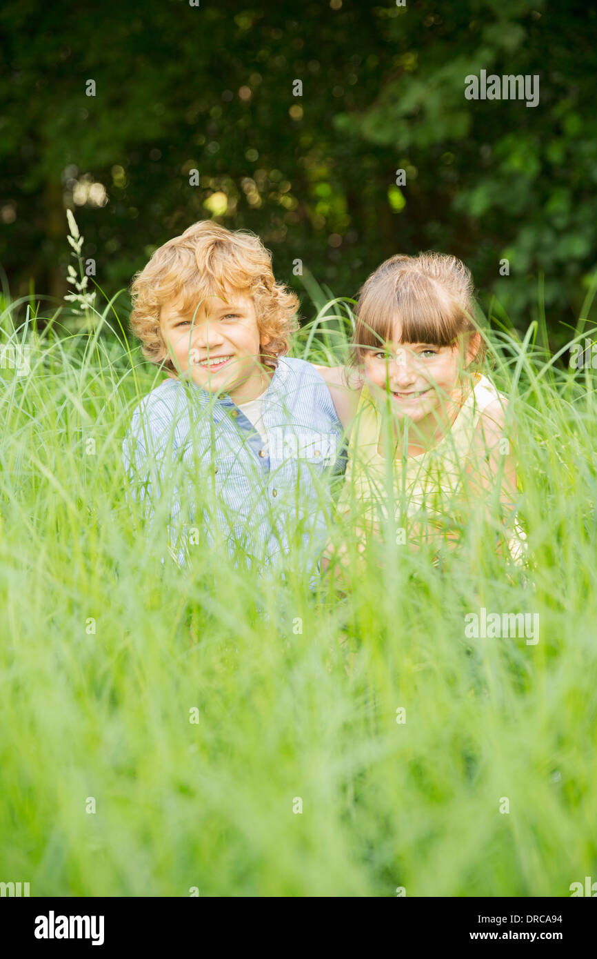Children playing in tall grass Stock Photo - Alamy