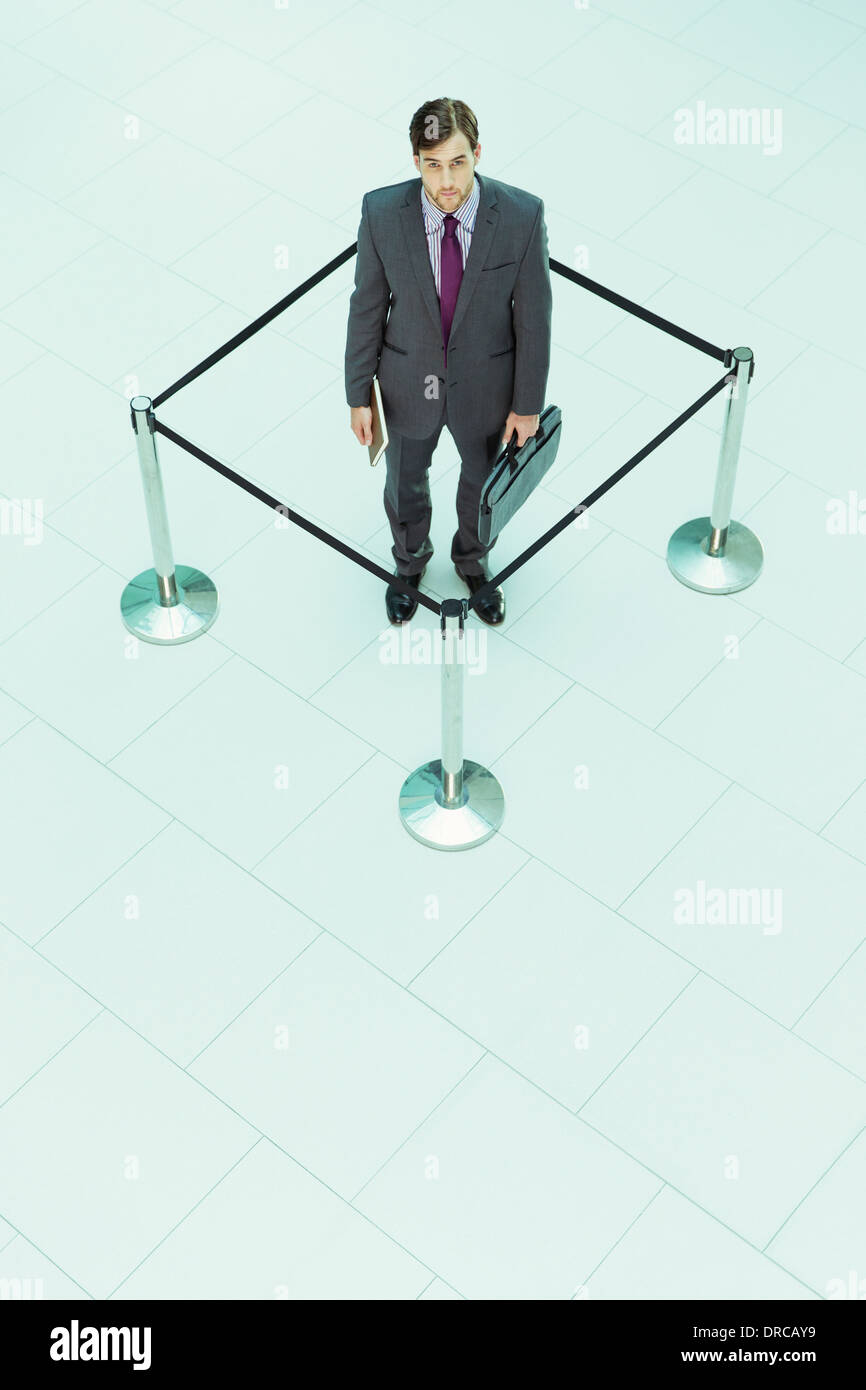 Businessman standing in roped-off square Stock Photo - Alamy