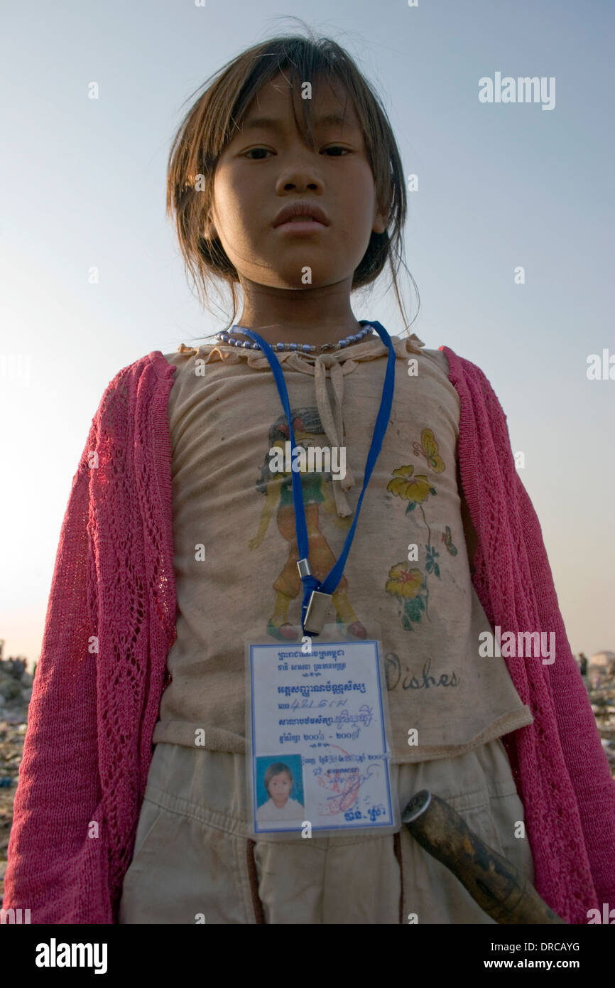 A young child laborer girl is standing in the toxic Stung Meanchey ...