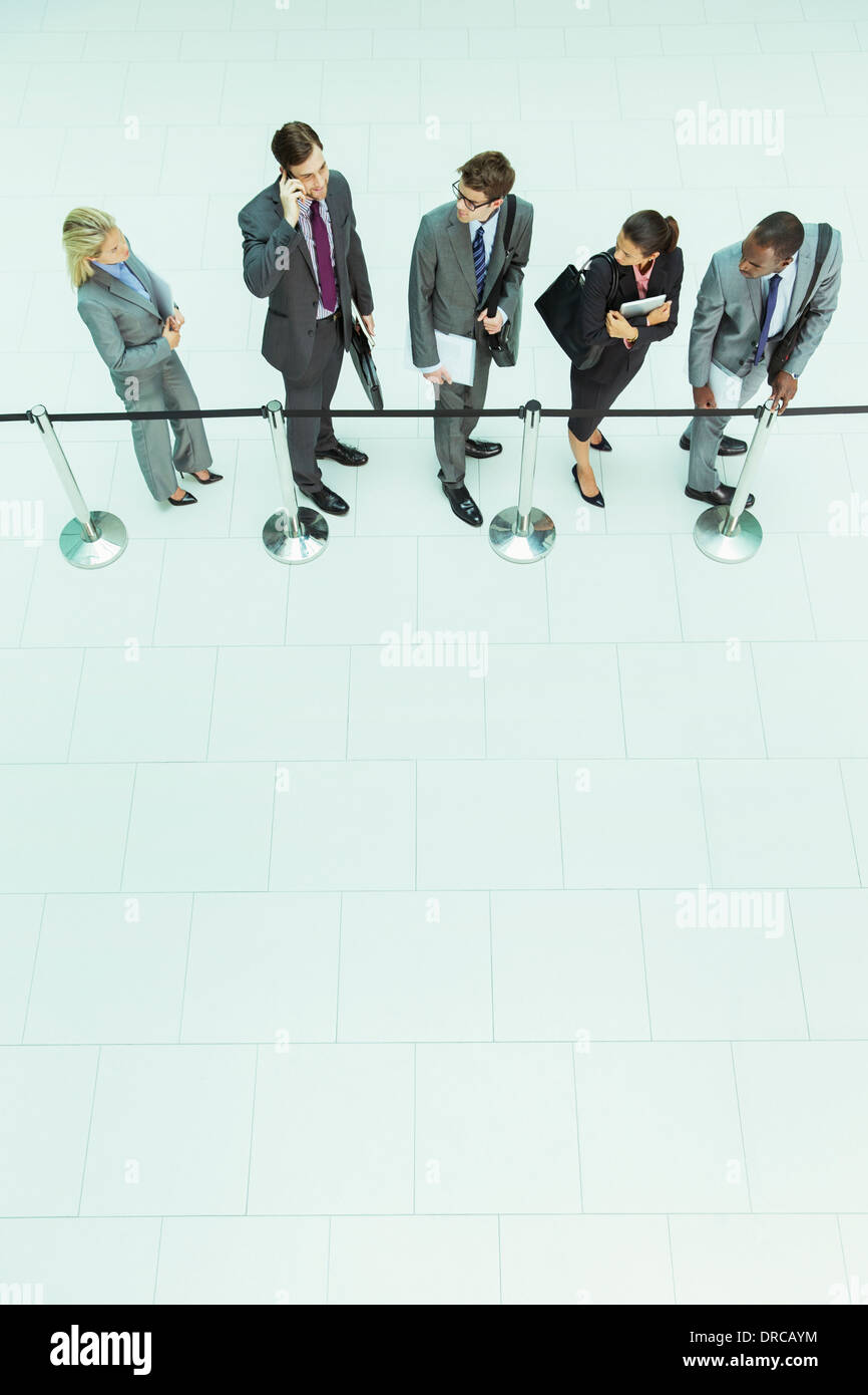 Businessman talking on cell phone in waiting area Stock Photo - Alamy