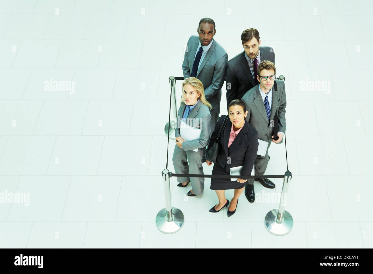 Business people standing in roped-off square Stock Photo - Alamy