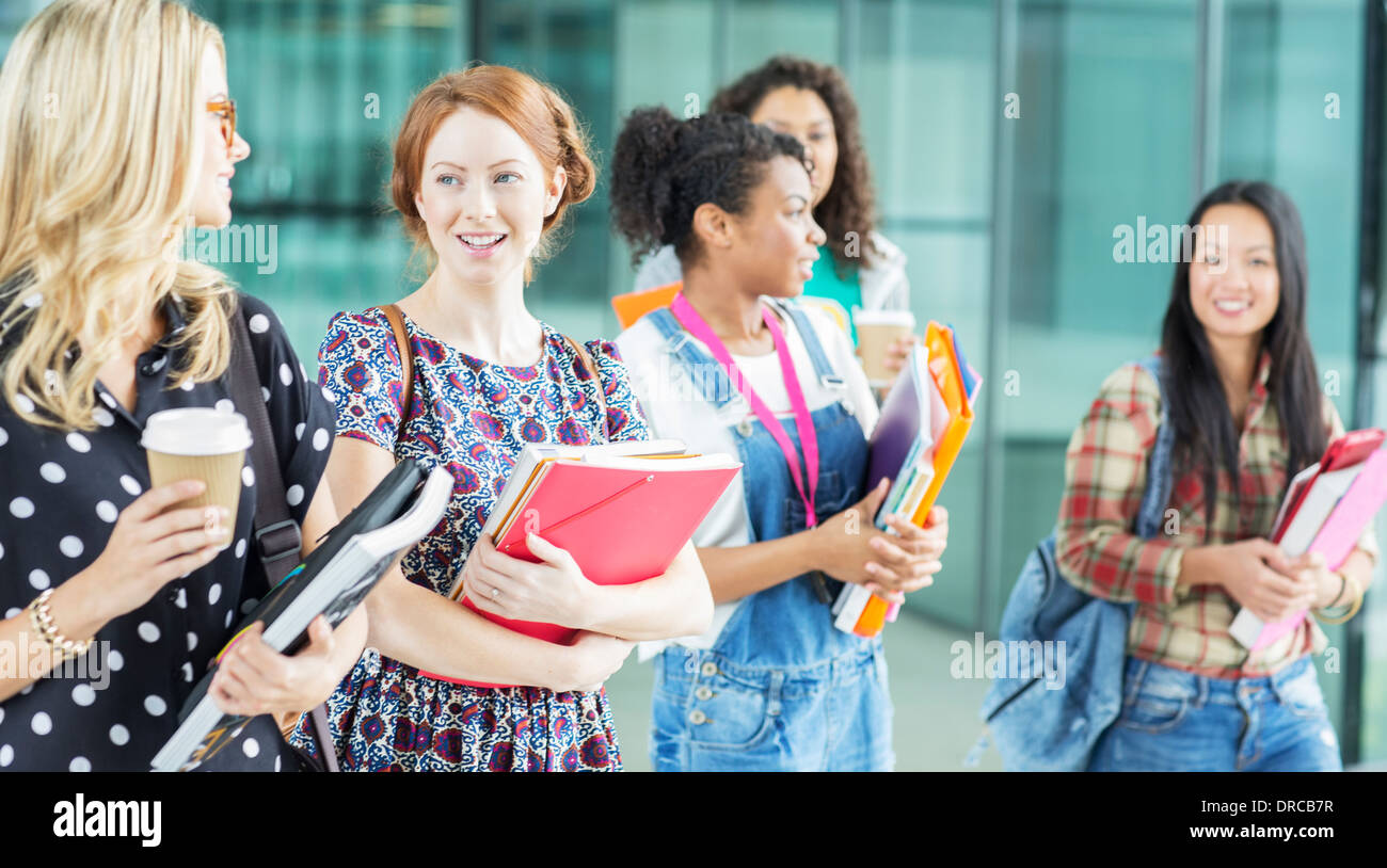 University students walking with books Stock Photo - Alamy