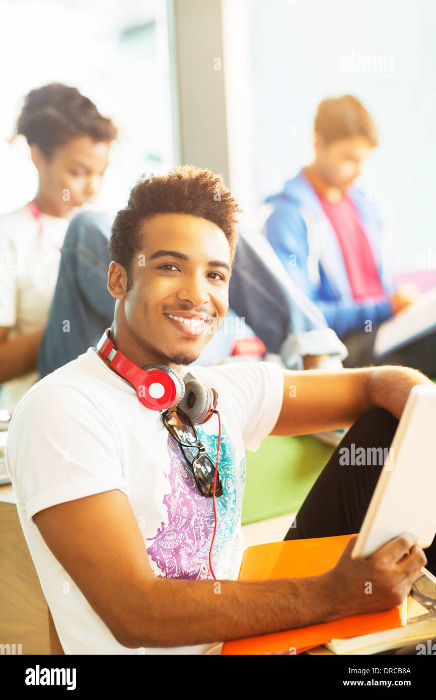 University students using digital tablet in lounge Stock Photo - Alamy