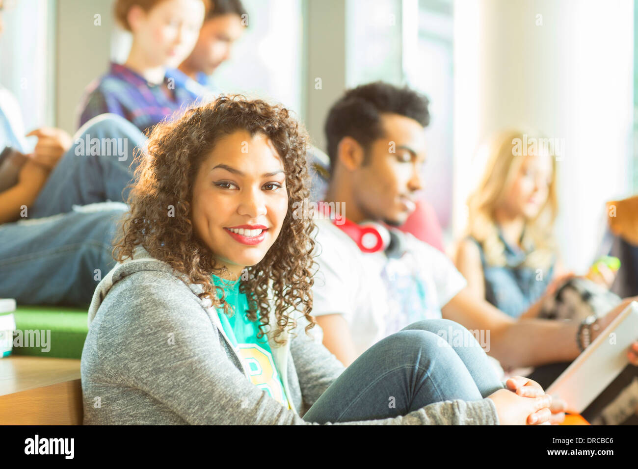 University student smiling in lounge Stock Photo - Alamy