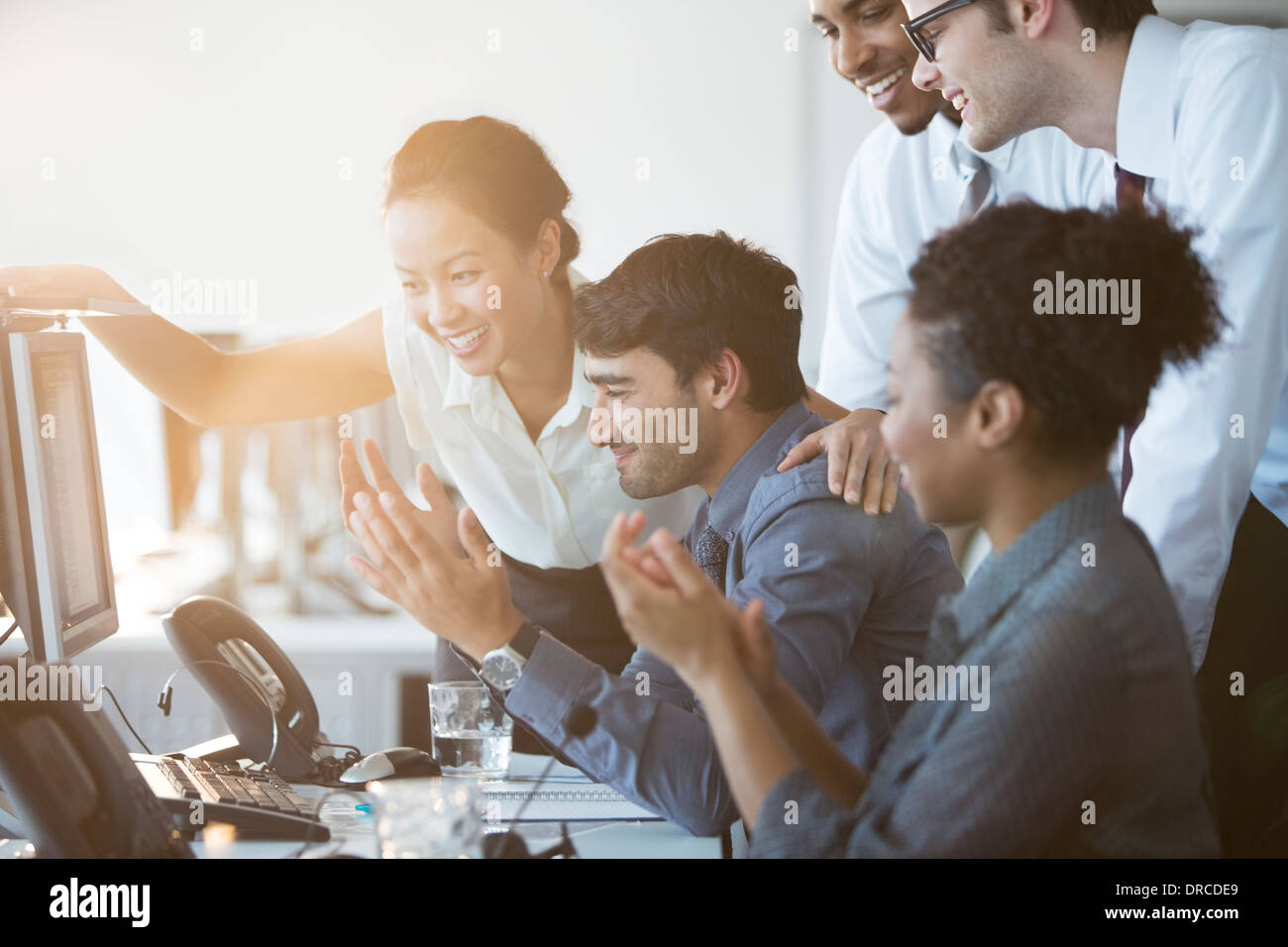 Business people cheering at computer in office Stock Photo - Alamy