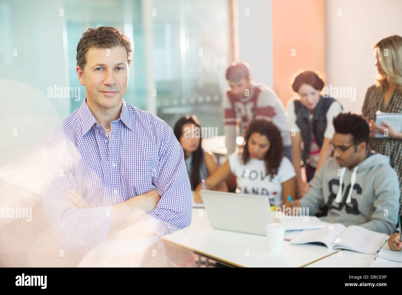 Professor standing in classroom Stock Photo - Alamy