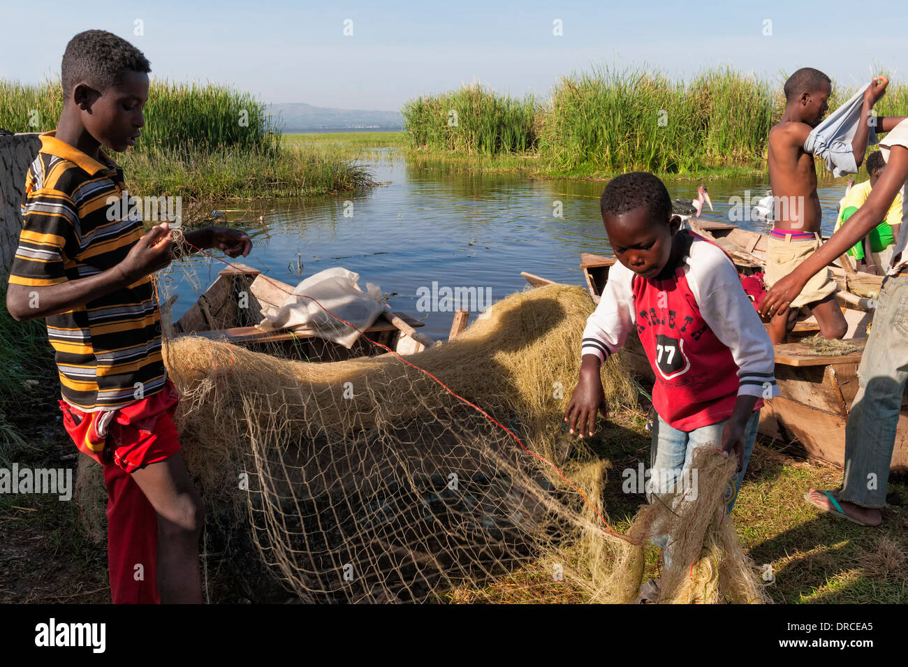 Boys preparing fishing nets, Awasa, Ethiopia Stock Photo - Alamy