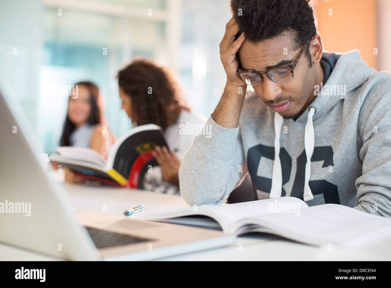 University student reading in classroom Stock Photo - Alamy