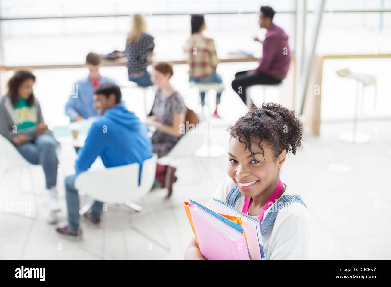 University student smiling in lounge Stock Photo - Alamy