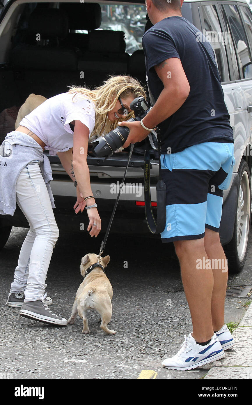 Sarah Harding packs her dogs in the back of her car after walking them ...
