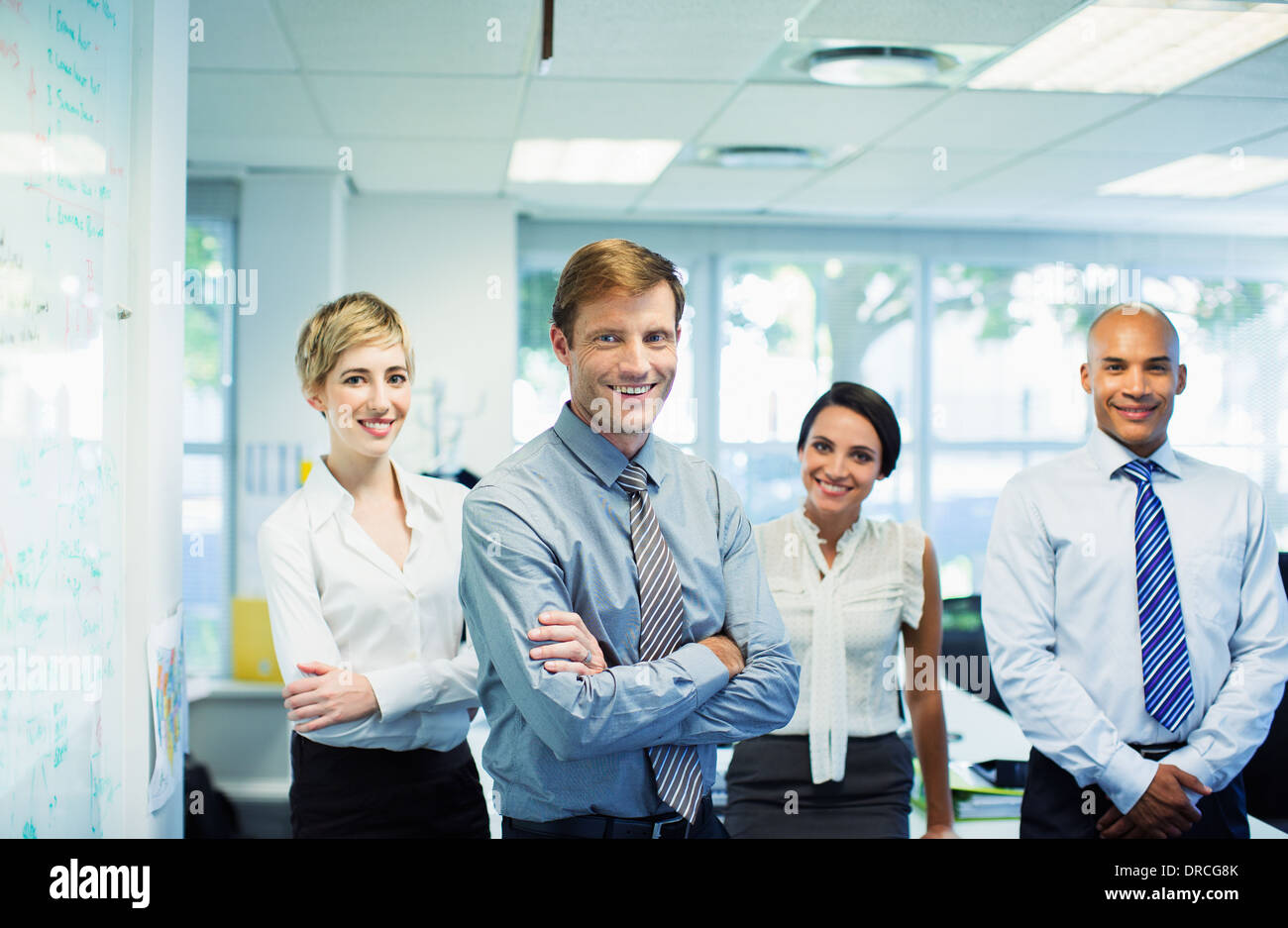 Business people smiling in office Stock Photo - Alamy
