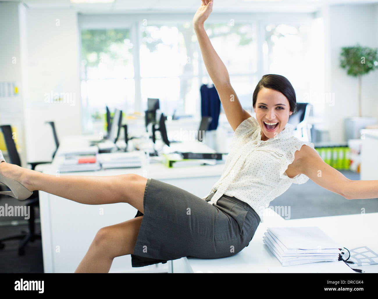 Businesswoman cheering in office Stock Photo - Alamy