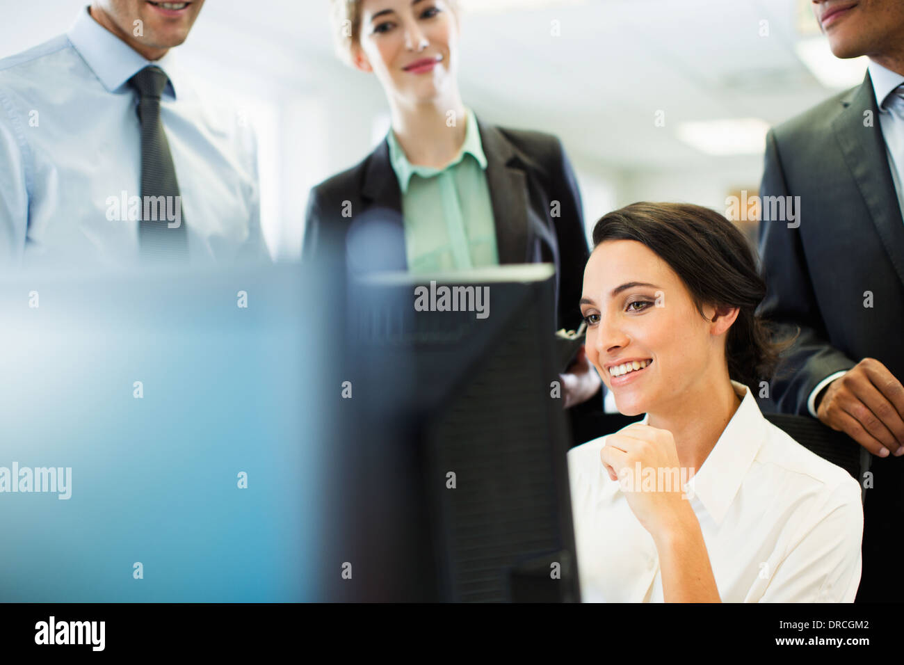 Business people talking at computer in office Stock Photo - Alamy