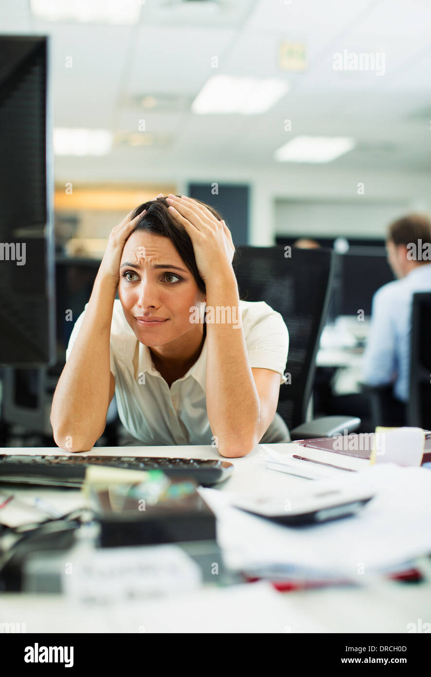 Woman grimacing at office desk hi-res stock photography and images - Alamy