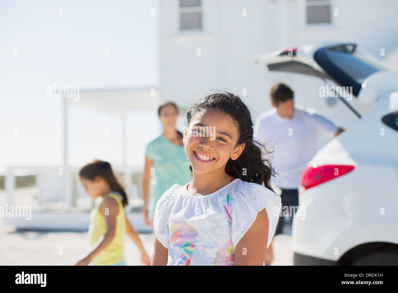 Girl smiling in sunny driveway Stock Photo - Alamy