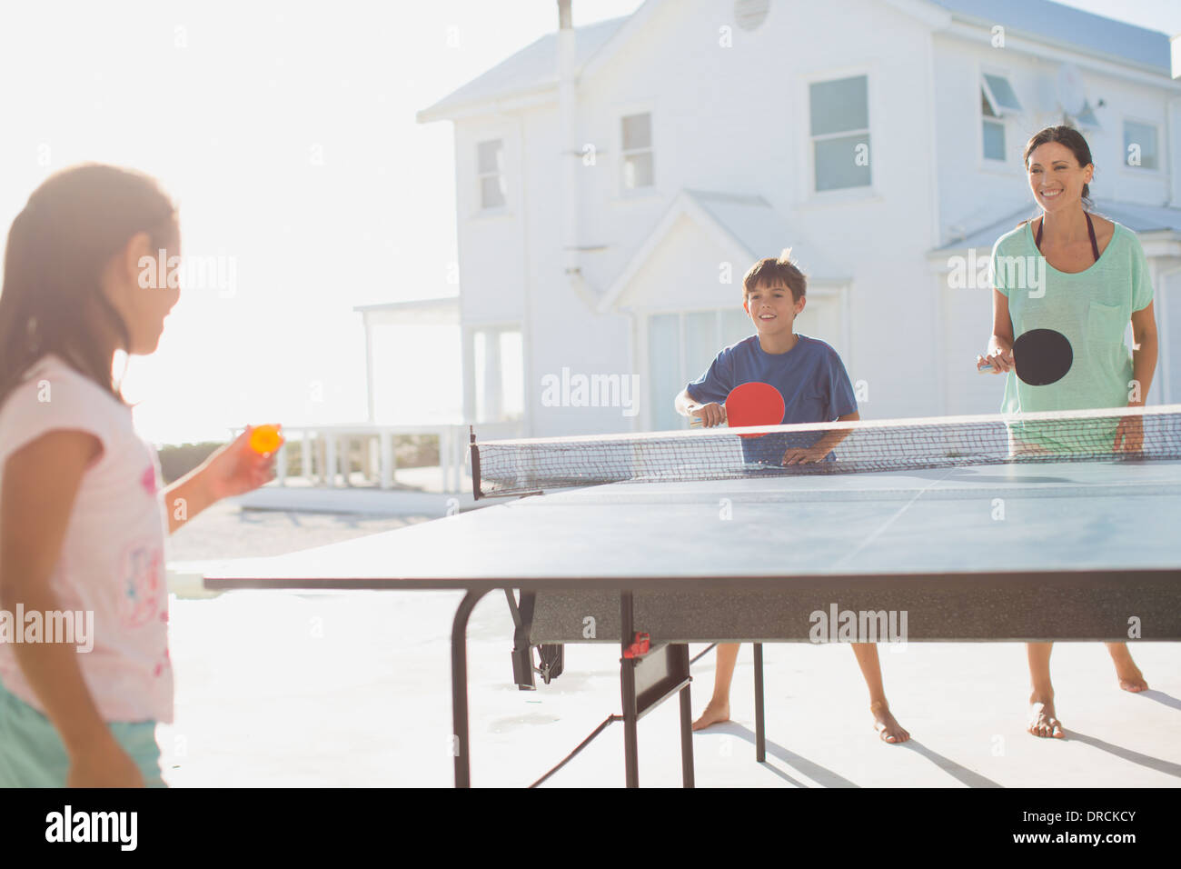 Family playing table tennis together outside house Stock Photo - Alamy