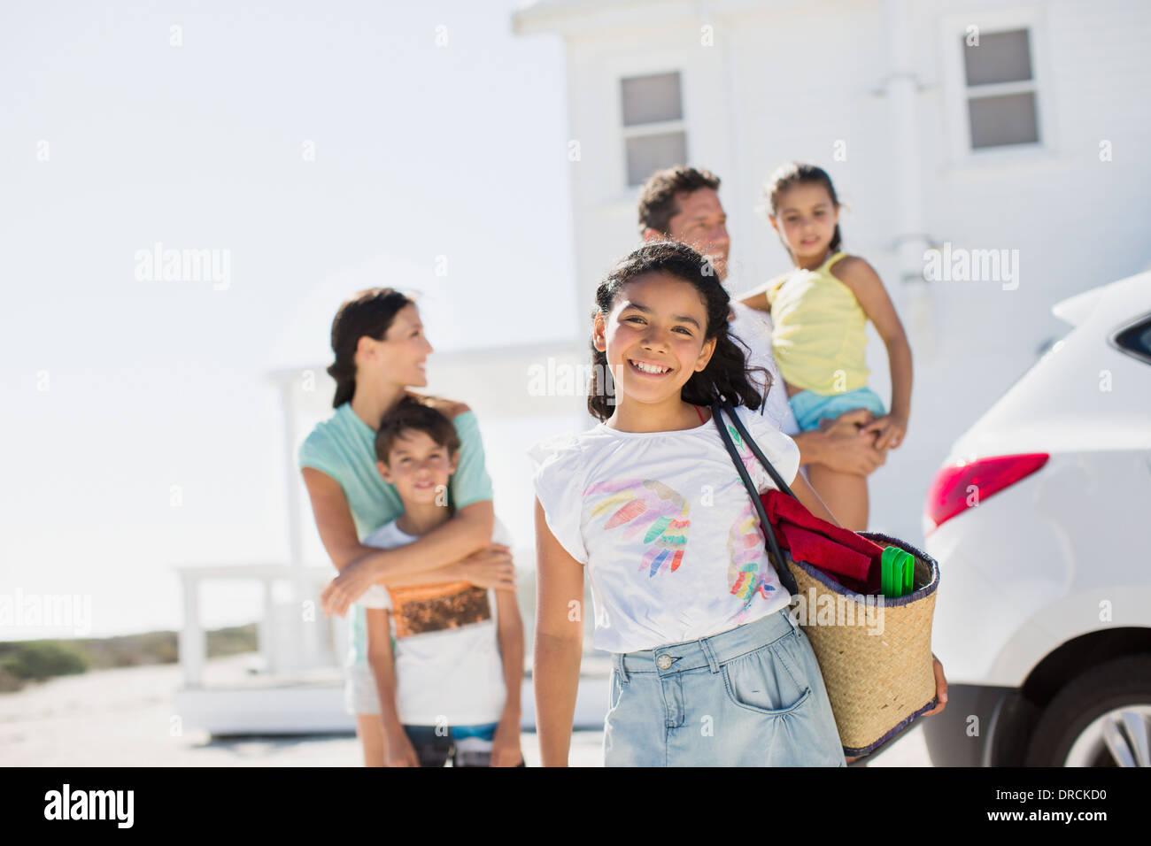 Family smiling in sunny driveway Stock Photo - Alamy