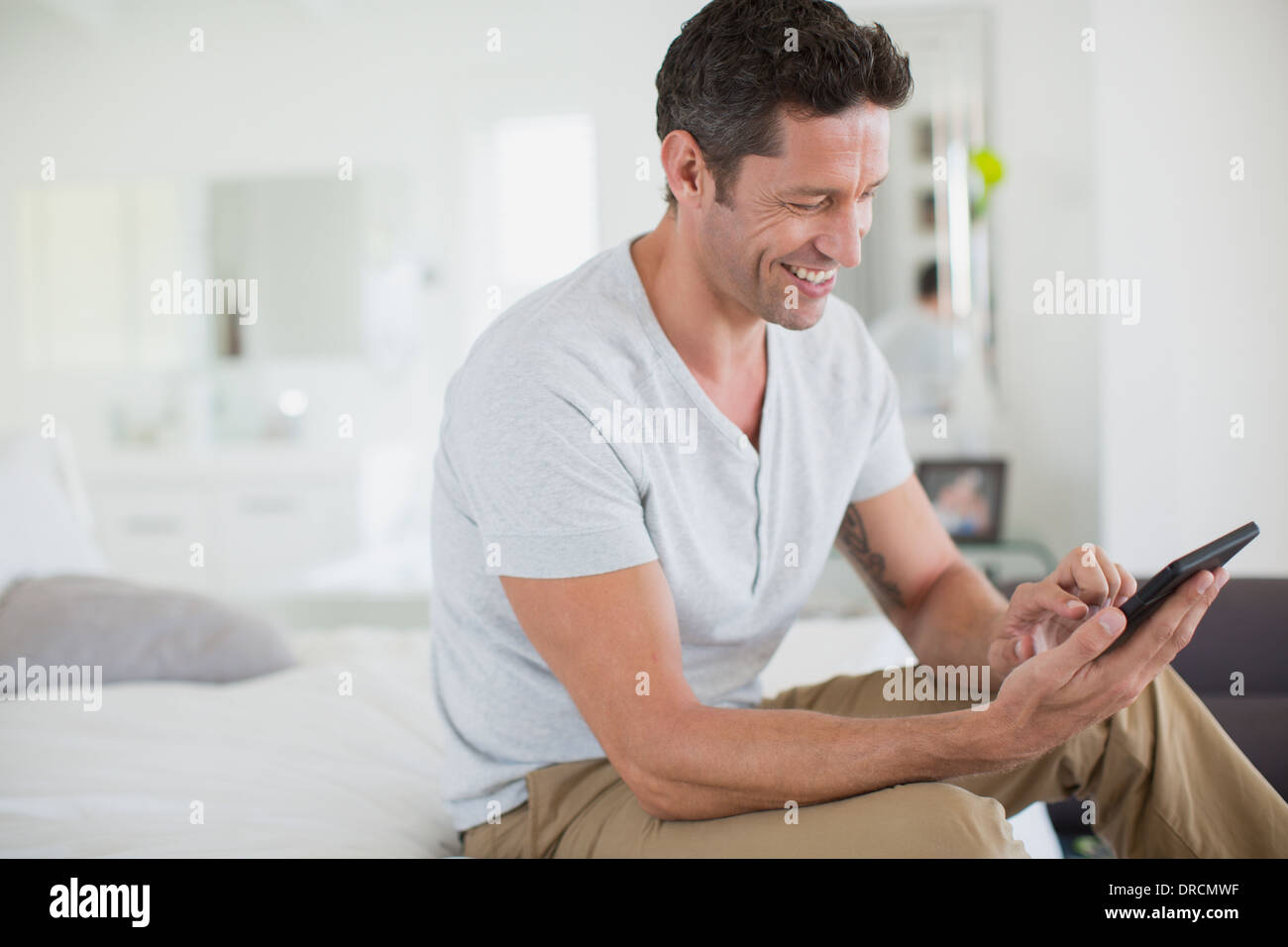Man sitting on edge bed hi-res stock photography and images - Alamy