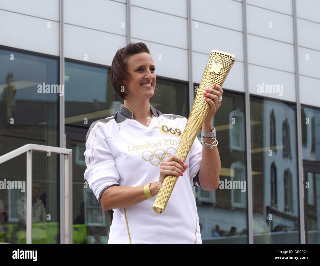 Karen Pickering carries the Olympic Torch on day 62 of the relay at the ...
