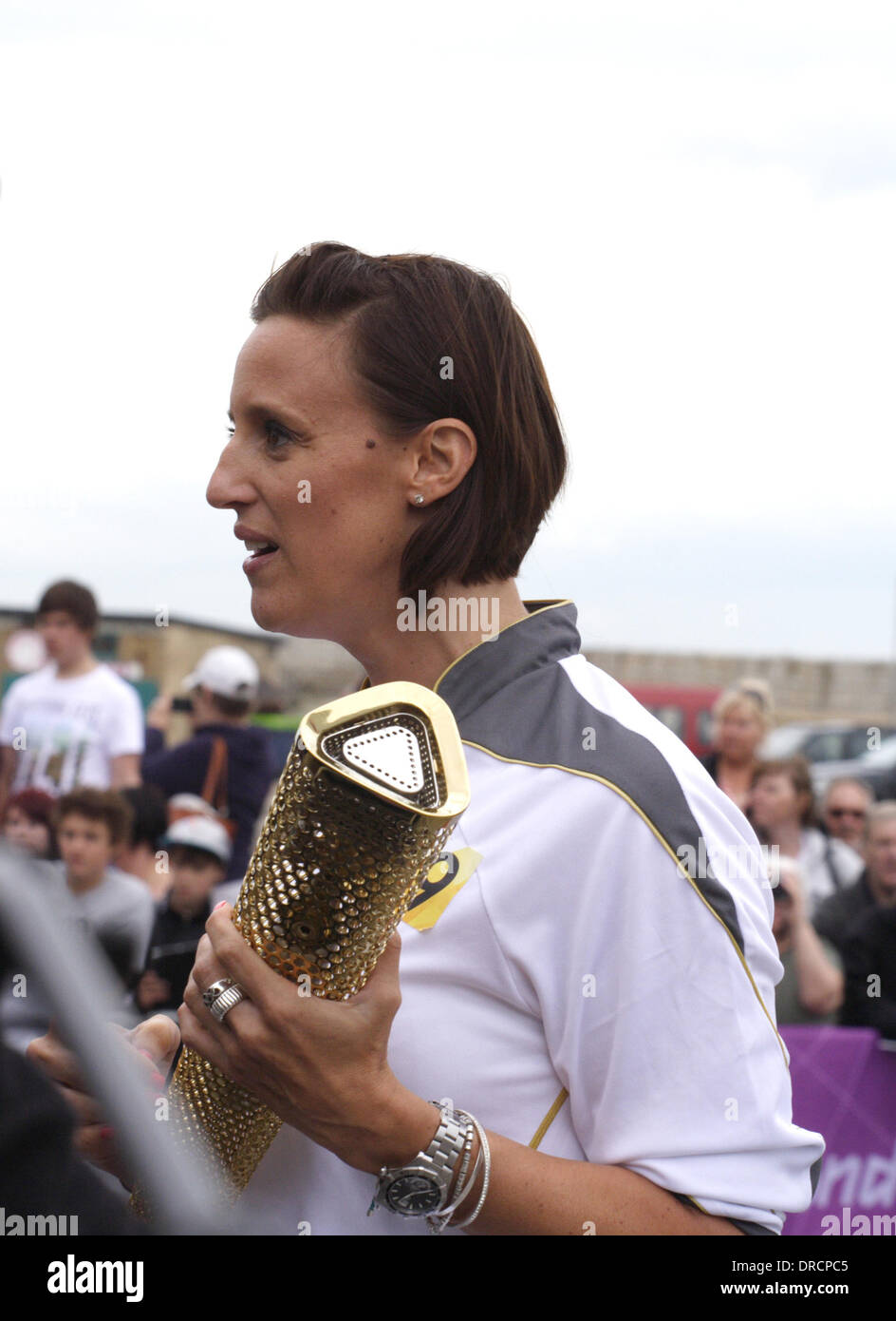 Karen Pickering carries the Olympic Torch on day 62 of the relay at the ...