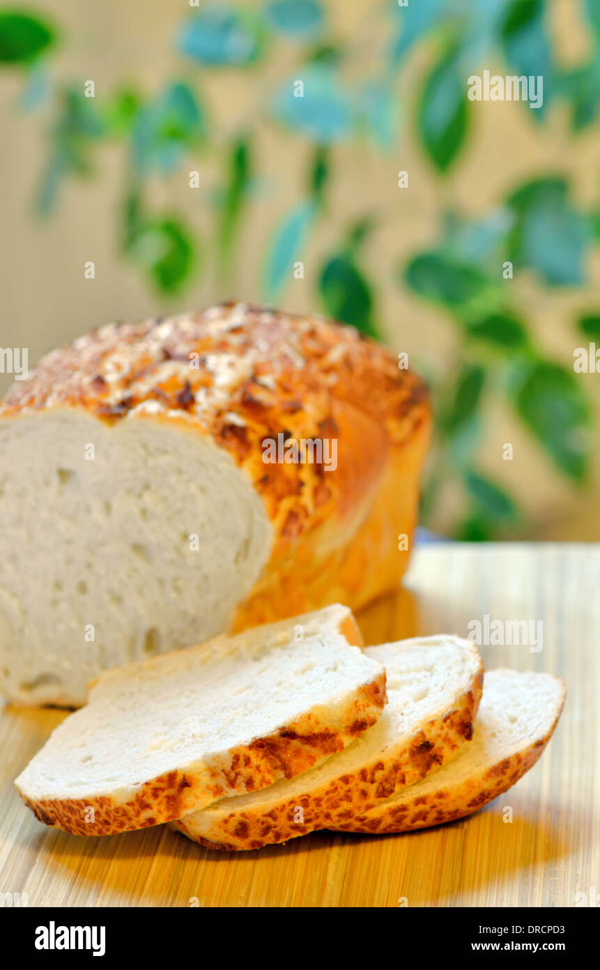Sliced loaf of white bread on wooden background Stock Photo - Alamy