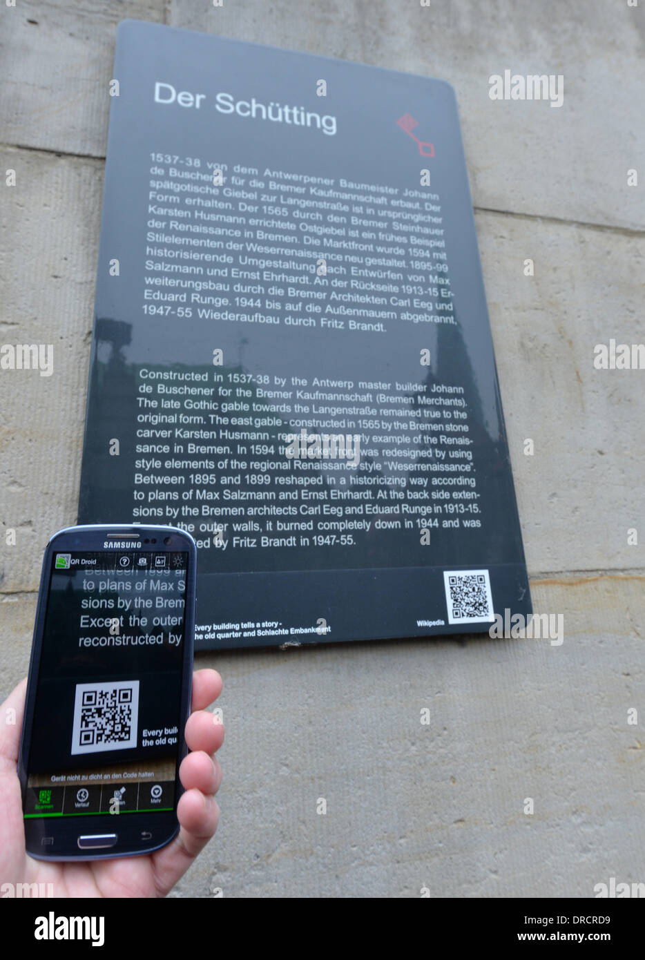 Bremen, Germany. 23rd Jan, 2014. A tourist scans a qr code on an ...
