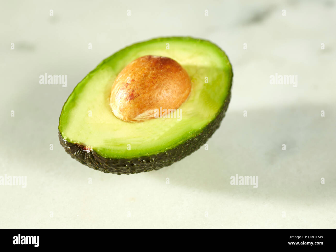 Avocado cut in half Stock Photo - Alamy