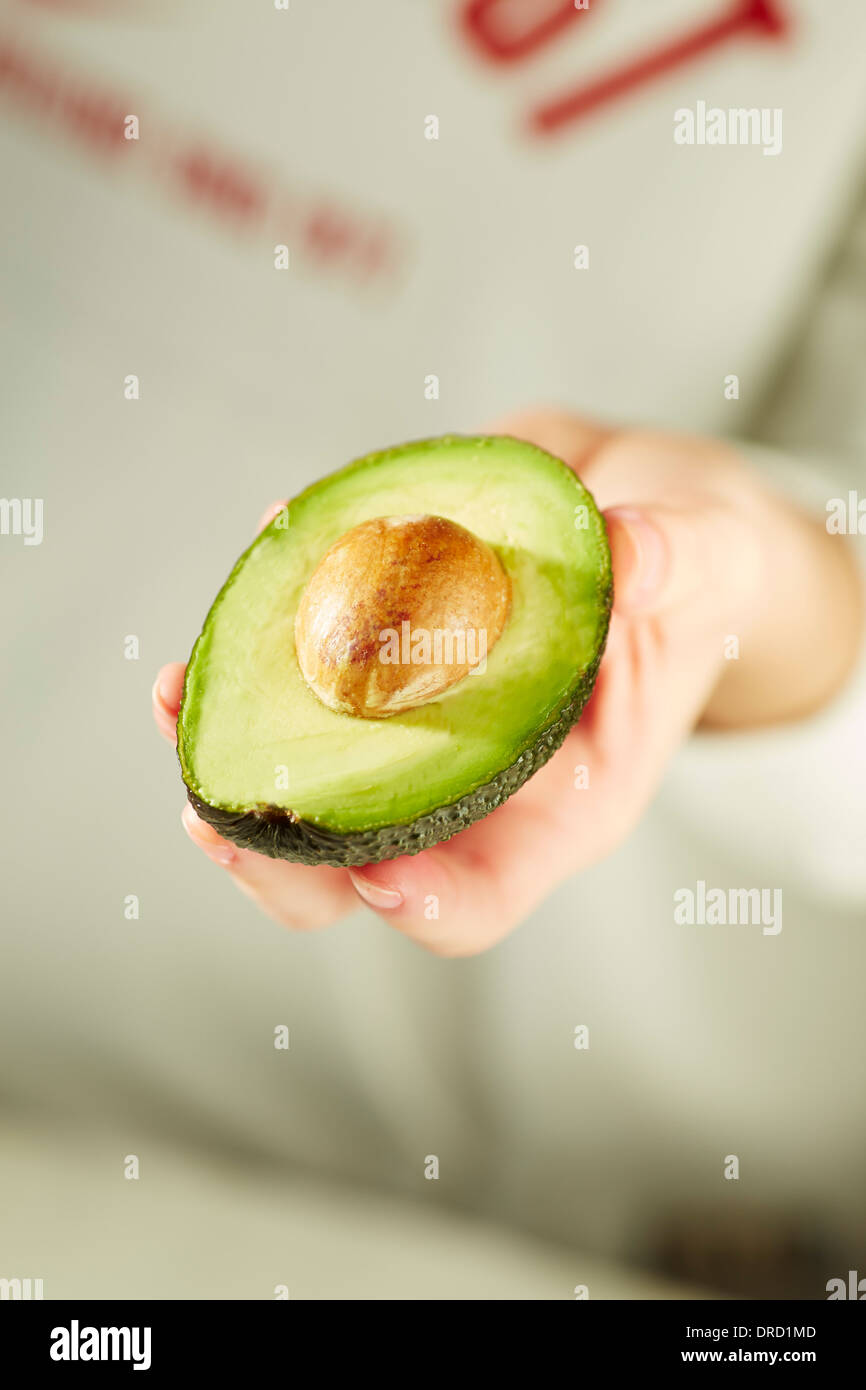 Woman eating Avocado Stock Photo - Alamy