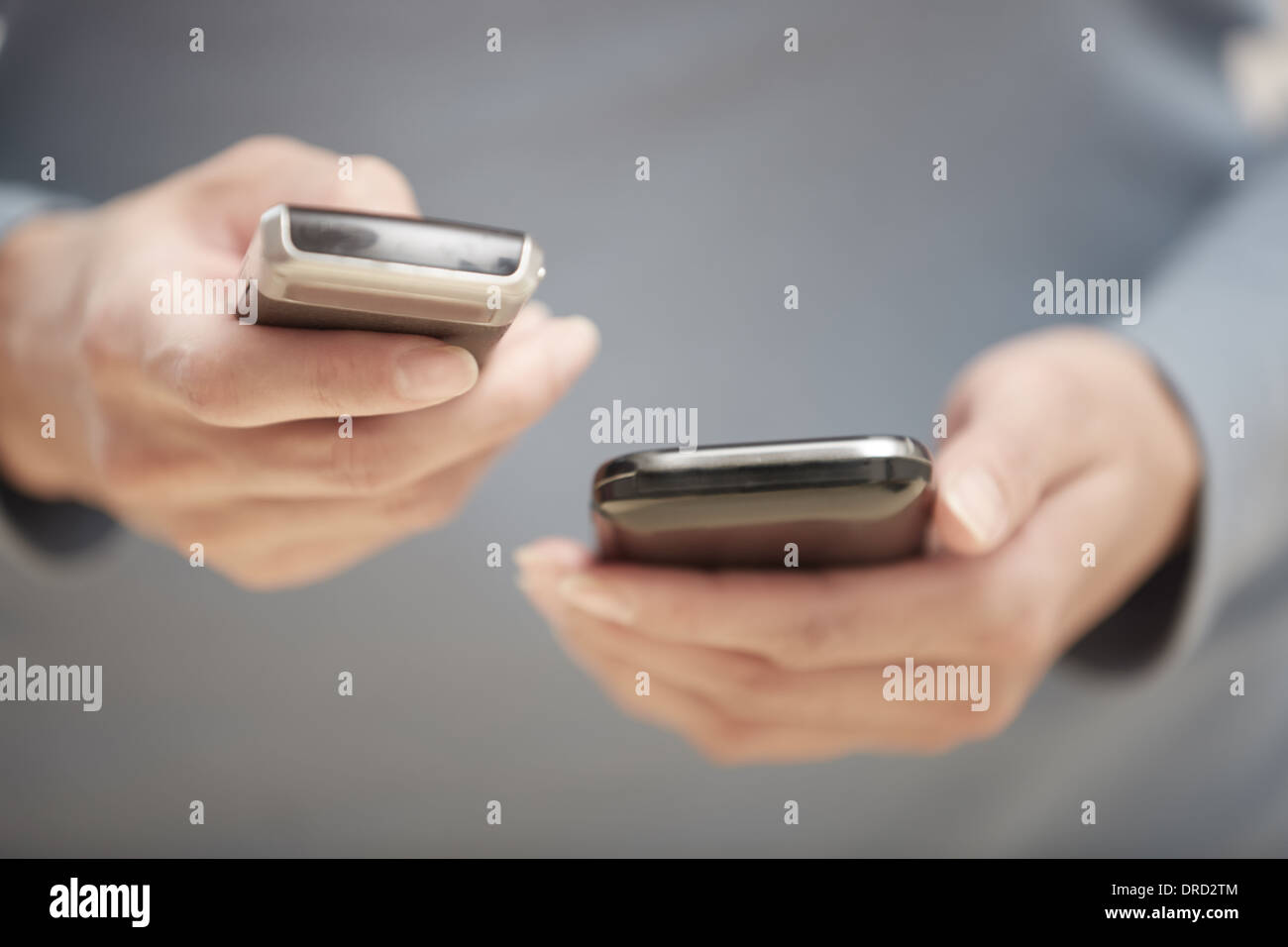 Human hands using two smartphones for data transfer Stock Photo - Alamy
