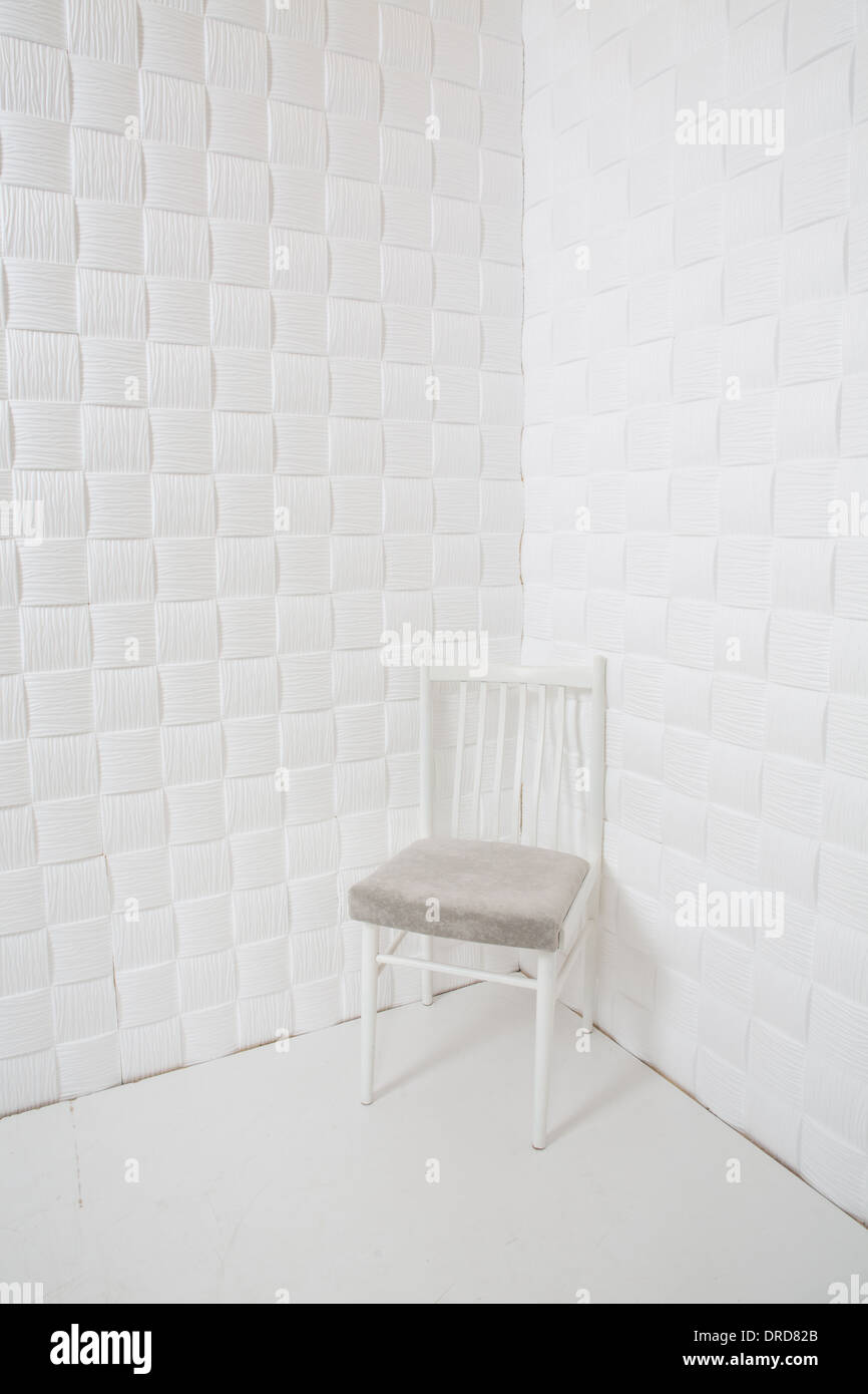 Empty chair isolated in white soft wall room Stock Photo - Alamy