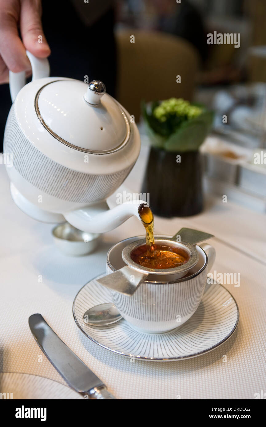 A classic English cup of tea poured by a waiter in a London Hotel Stock ...