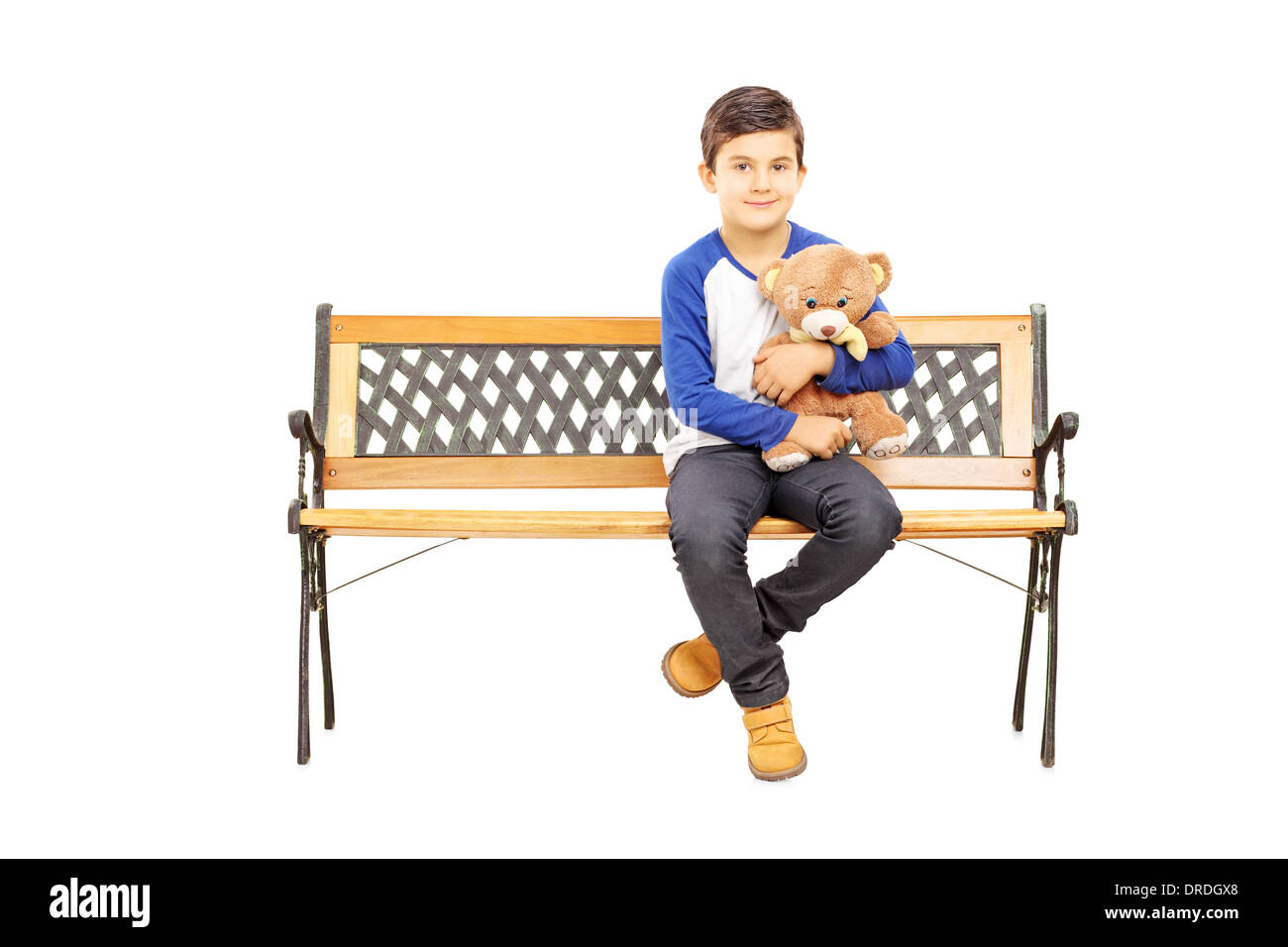 Young boy sitting on bench and holding teddy bear Stock Photo - Alamy