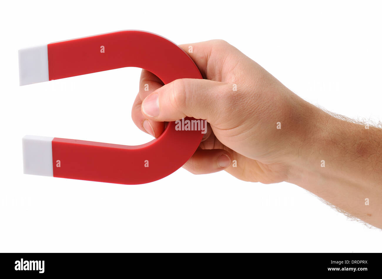 A hand holding a magnet isolated on white to pick up an object Stock ...