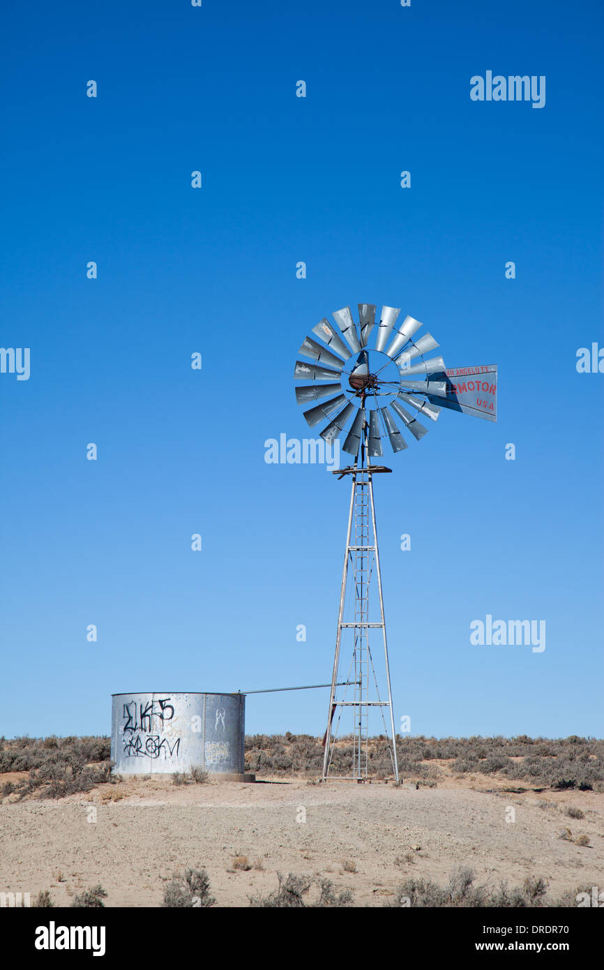 An old Aermotor windmill is pumping water into a tank for cattle in the ...