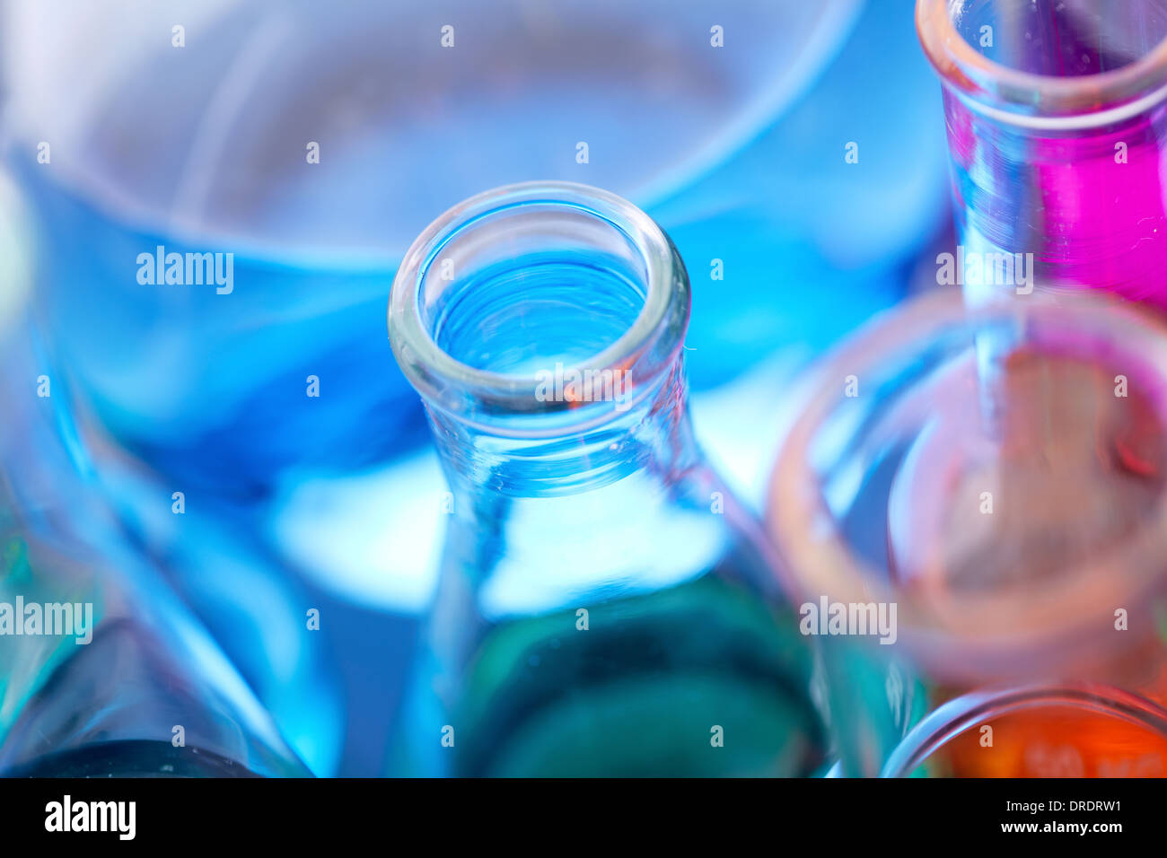Image of several flasks with multi-color liquids, focus on one of them ...