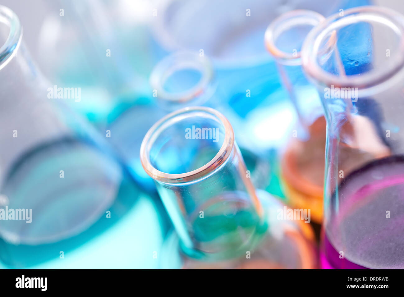 Image of several flasks with multi-color liquids, focus on one of them ...