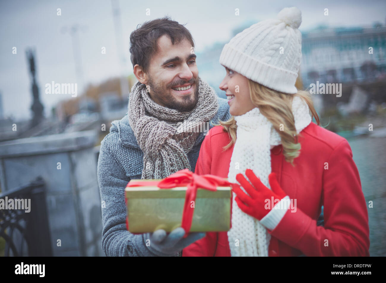 Image of affectionate guy giving present to his girlfriend outside ...