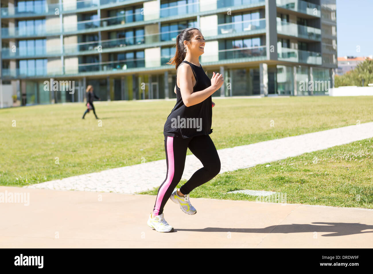 A beautiful young woman making some exercise at the park - fitness ...